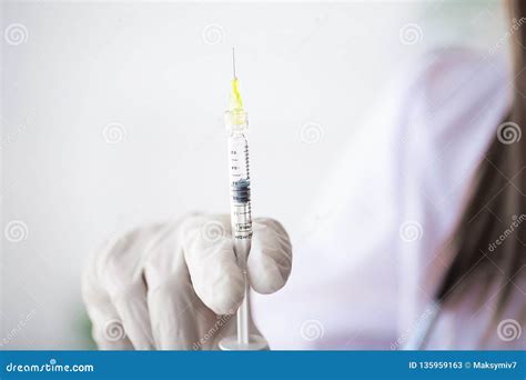Female Doctor Or Physician Holding Hypodermic Syringe With Injection
