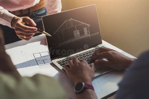 Two Professional Architects Discussing House Building Plan Design Project With Looking