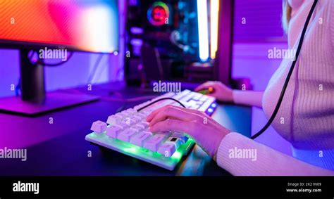 Close Up Gamer Hands Actively Pushing Buttons With Colorful Neon LED Lights Woman Guy Typing On
