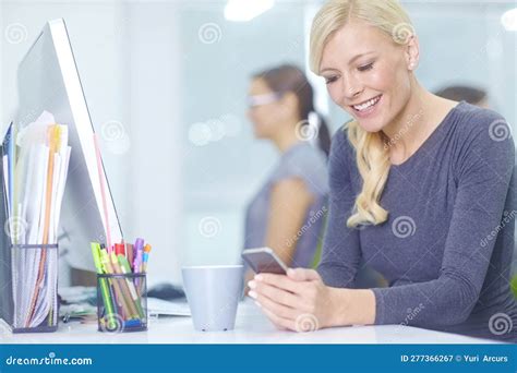 Syncing Your Phone And Computer Is Seamless A Young Woman Using A Cellphone While Sitting At