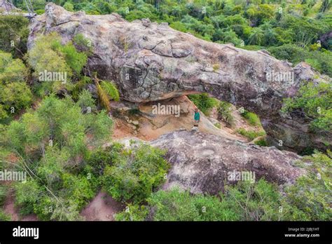 A Man Under The Rock Arch On Cerro Arco In Tobati In Paraguay Stock