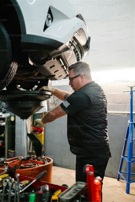 차고에서 차를 다루는 남자 사진 Unsplash의 자동차 정비사 이미지