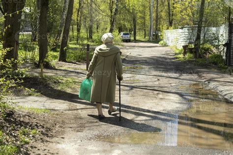 Pensioner Walks Down Street Grandmother In Russia Woman With Walking