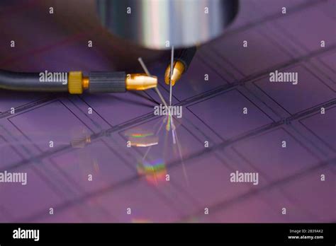 close up of examining a sample of microchip transistor with probe