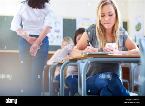 Female Babe In Classroom Cheating During An Exam Stock Photo Alamy