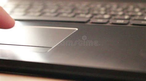 Businessman Scrolling On A Laptop Keyboard In Blurred Focus Stock