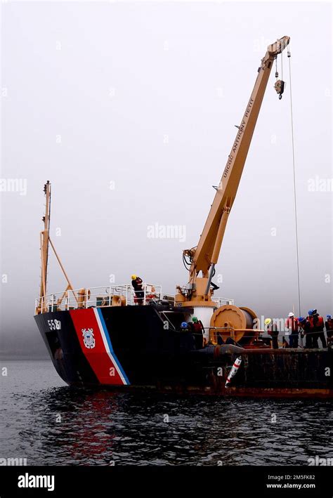 Us Coast Guardsmen Use A Boom Crane To Lift An Inert Training Aid
