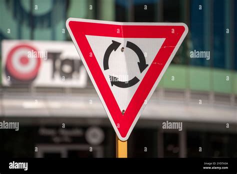 A Roundabout Traffic Sign In Perth Australia Featuring A Red Triangular Border And Black