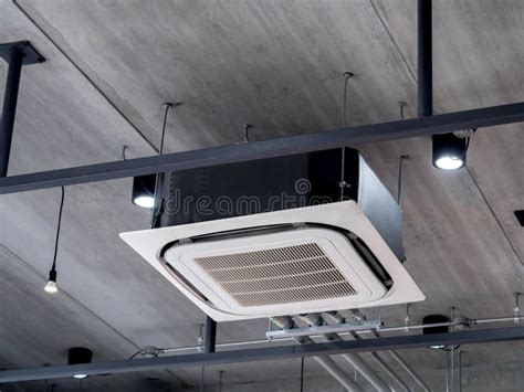 Ceiling Mounted Cassette Type Air Conditioner Decoration Near The Spot Lights On The Concrete