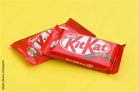 Kit Kat Chocolate Bar In Red Wrapping Lies On Yellow Background Kit Kat Created By Rowntrees