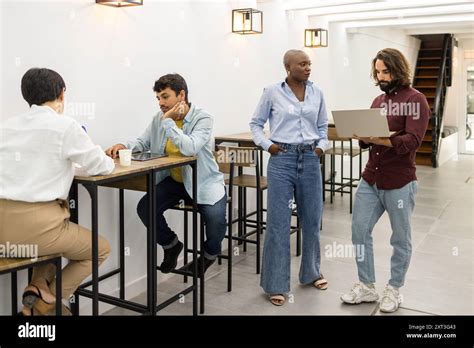 A Diverse Group Of Professionals Collaborates In An English Academy