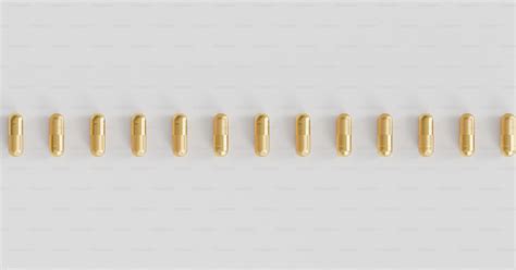 흰색 바탕에 금색 구슬 행 사진 Unsplash의 알 약 이미지