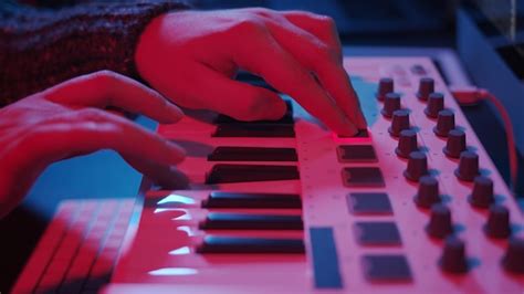 Premium Photo Hands Using Midi Keyboard In Home Studio In Night With Neon Lights