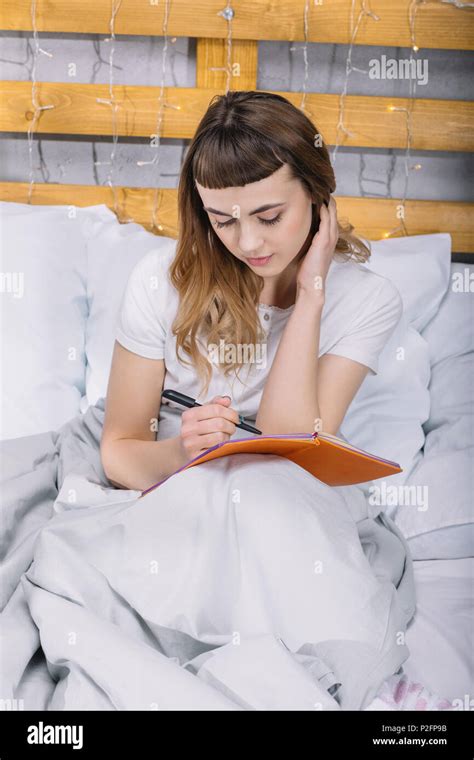 Girl Writing Something To Notebook In Bed In Morning Stock Photo Alamy