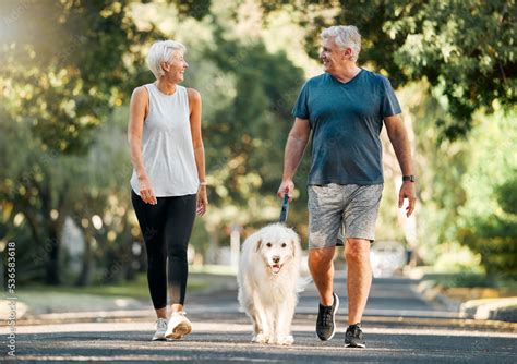Retirement, fitness and walking with dog and couple in neighborhood ...