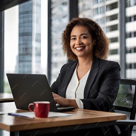 A Woman Sits At A Table With A Laptop And Coffee Premium Ai Generated
