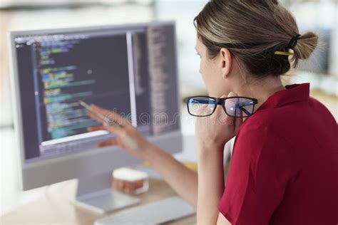 Female Programmer Checks Code Looking At Screen Of Computer Stock Image