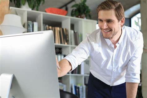 Young Modern Business Man Analyzing Data Using Computer While Working In The Office Stock Image