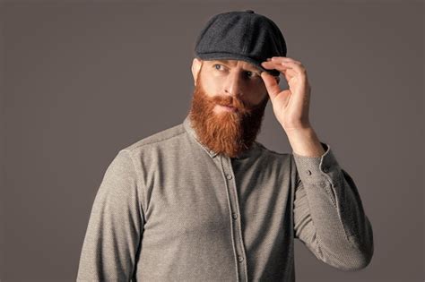 Premium Photo Serious Irish Guy Adjusting Cap Portrait Of Bearded Guy Unshaven Guy With Beard