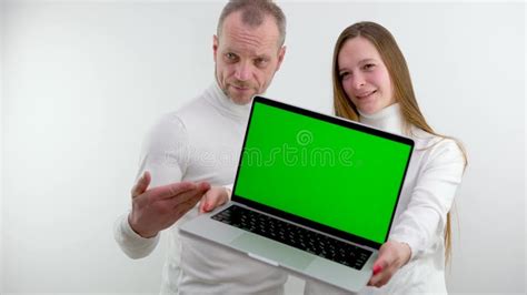 Serious Adult Man And Girl Showing A Laptop Screen With His Hand Space For Advertising Text
