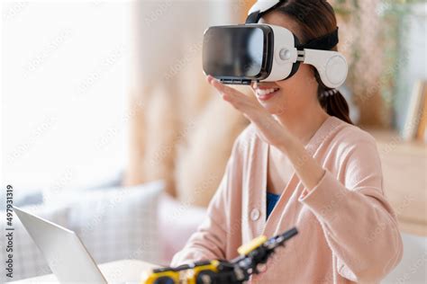 Smart Asian Female Programer Wear Vr Control Learning Robot Arm Ai