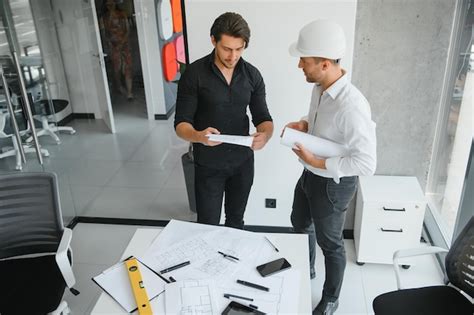 Premium Photo Engineer Or Architect Teamwork Working On Construction Project With Building