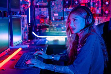 Woman Hacker Sitting In Front Of A Computer Typing On Keyboard Hacking