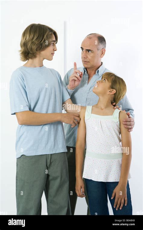 Father Shaking His Finger At Teen Son Preteen Daughter Watching And Stock Photo Royalty Free