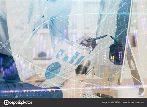 Double Exposure Of Chart With Businessman Typing On Computer In Office On Background Concept Of