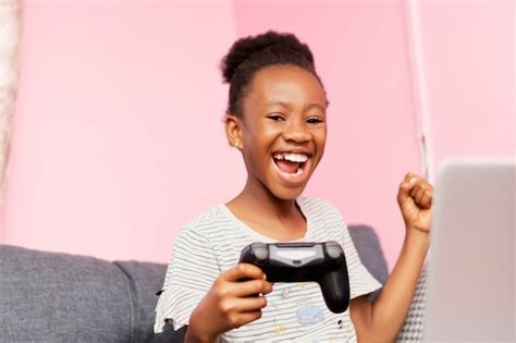 Premium Photo Young African Girl Enjoying A Wireless Game Controller