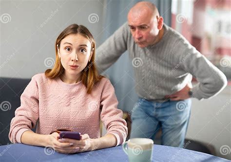 Man Controling How Woman Is Texting With Someone On A Mobile Phone Stock Image Image Of Adult