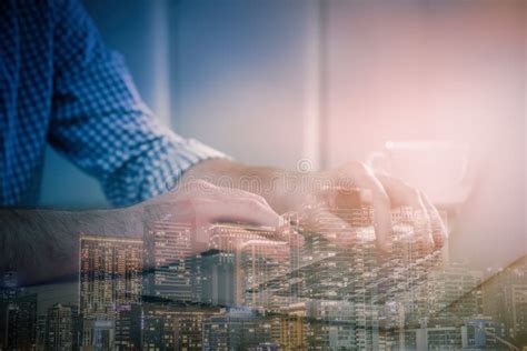 double exposure of male programmer using laptop and cityscape stock