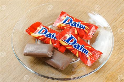 Daim Milk Chocolate And Caramel Candy On A Wooden Table Editorial