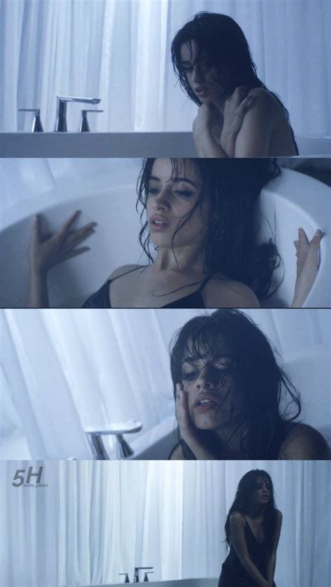 A Woman Sitting In A Bathtub With Her Hands On Her Face And The Other Half Of Her Body