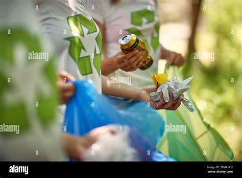 Close Up View Of Garbage Being Collected By Young Volunteers In The Forest On A Beautiful Summer