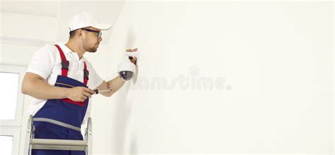 Mounting Security Camera On Wall Of House Ensuring The Security Of The Office Space Stock