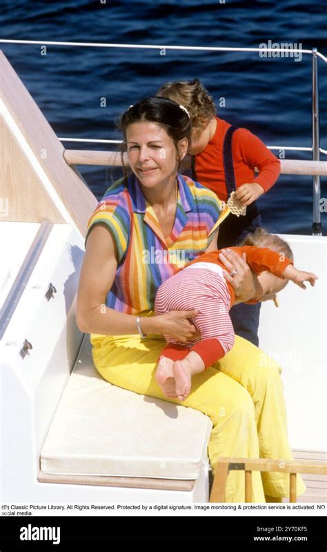 Queen Silvia Of Sweden With Her Son Prince Carl Philip In Her Lap On The Royal Boat Vacation