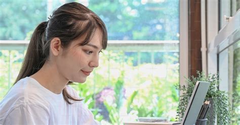 옆모습 젊은 여자 커피숍에 앉아 컴퓨터 태블릿을 사용하고 있다 사진 Unsplash의 태국 이미지