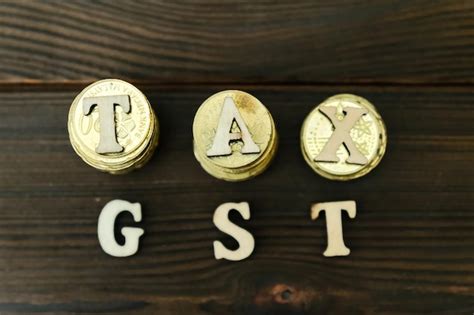 Premium Photo High Angle View Of Coins With Tax And Gst Text On Table
