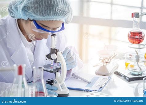 Female Scientist Look At Microscope Science Test Tube Analyse Scientific Sample In Laboratory
