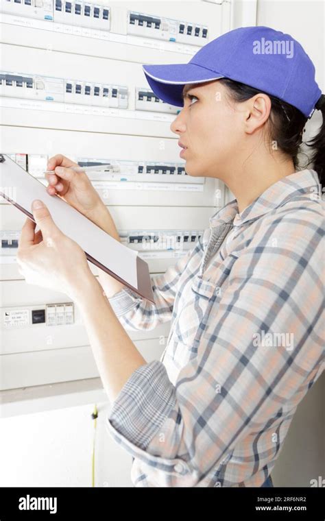 Female Worker During Survey Of Electrical Terminal Box Stock Photo Alamy