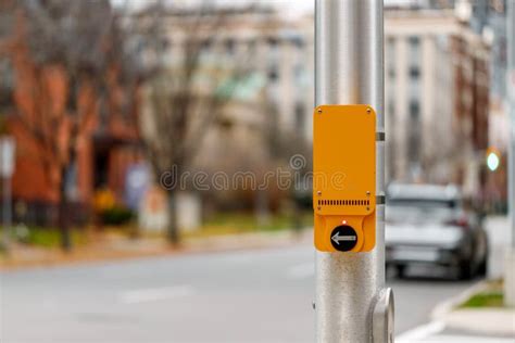 Yellow Pedestrian Push Button Sign On Traffic Signal Pole At Crossroad