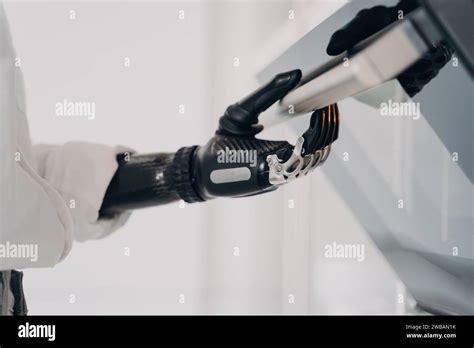 Precision And Technology Converge As A Bionic Hand Operates A Control Panel Symbolizing The New