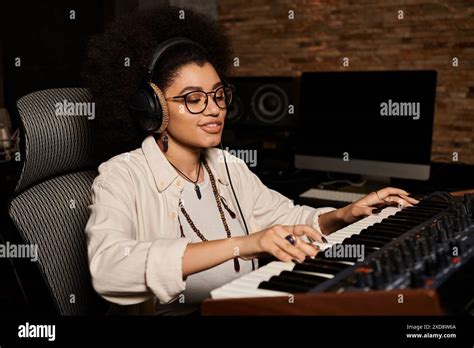 Talented Woman With Afro Hair Plays Keyboard In Music Band Rehearsal At Recording Studio Stock