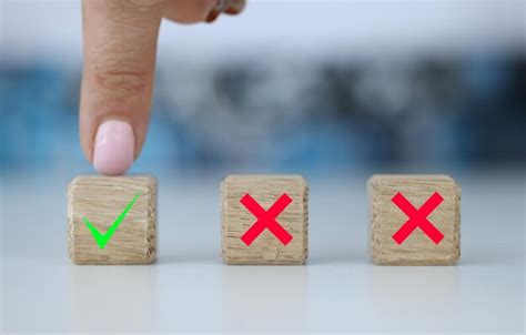 Premium Photo Hand Chooses Between Two Dice With Yes And No