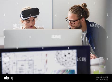 focused computer programmers programming virtual reality simulator