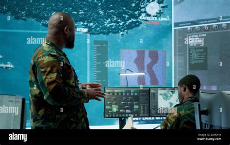 Military Team Operating In A High Tech Command Post Control Tower Focusing On Surveillance