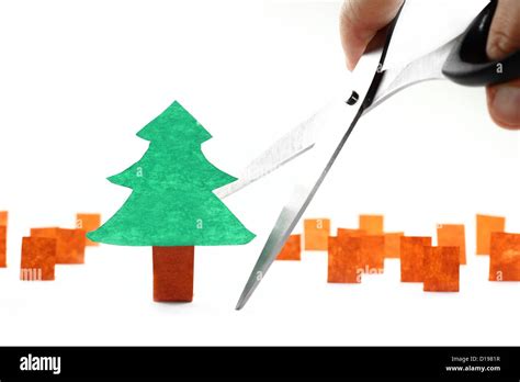 Small Paper Tree Cut By Opened Scissors With Already Destroyed Forest In The Background Stock
