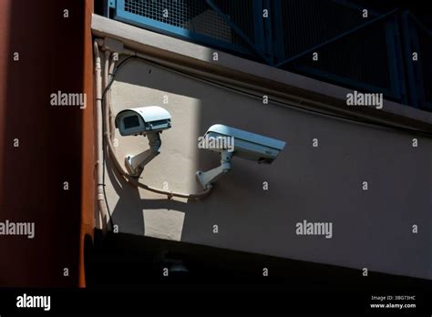 Two Surveillance Cameras Mounted On A Building Provide Security And