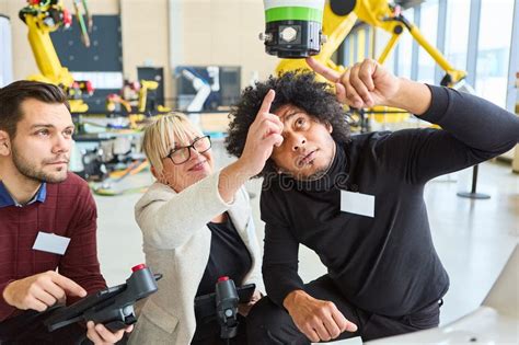 Team Of Engineers Working On Robotic Automation In A Modern Industrial